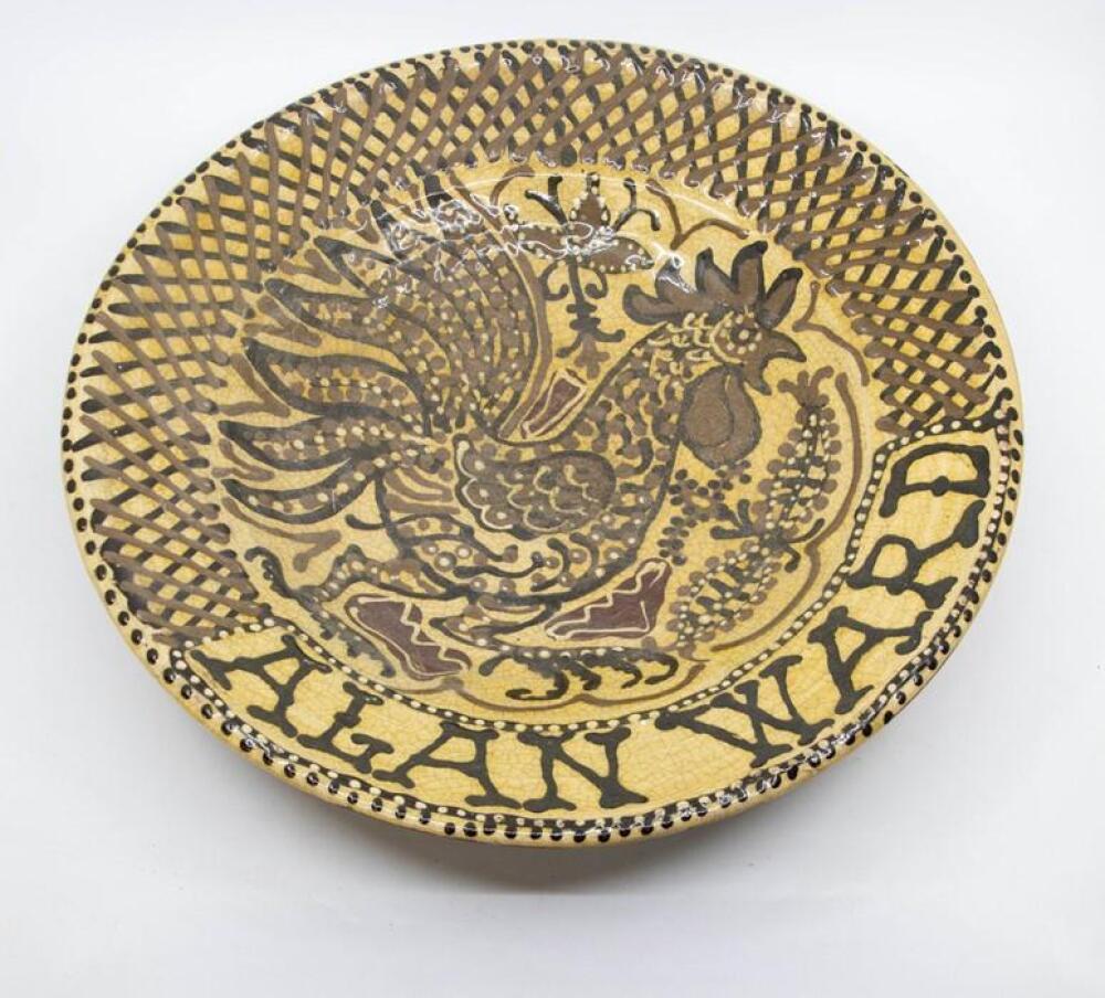A Thomas Toft style slipware charger decorated with a cockerel together ...