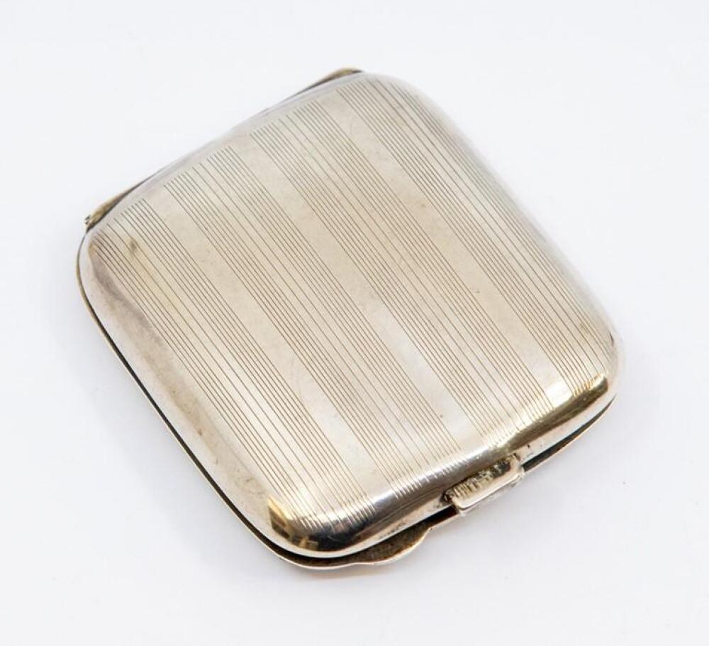 An Art Deco silver cased miniature travel clock, white enamel dial ...