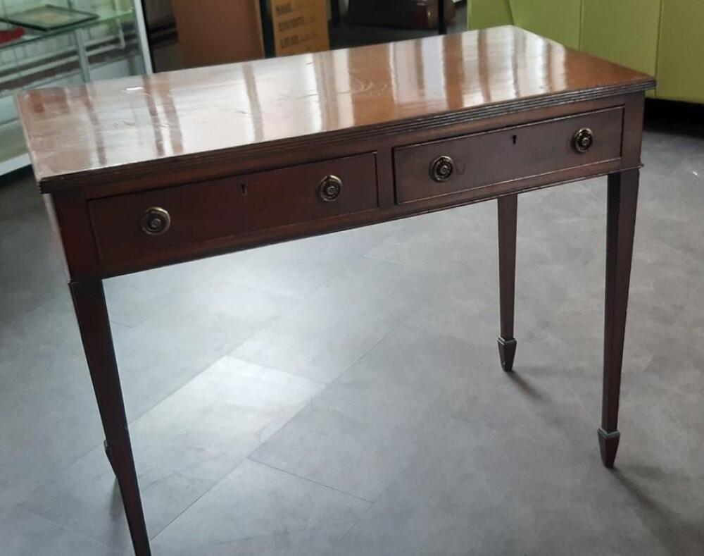 A Georgian style hallway table, with two draws, supported on tapered ...