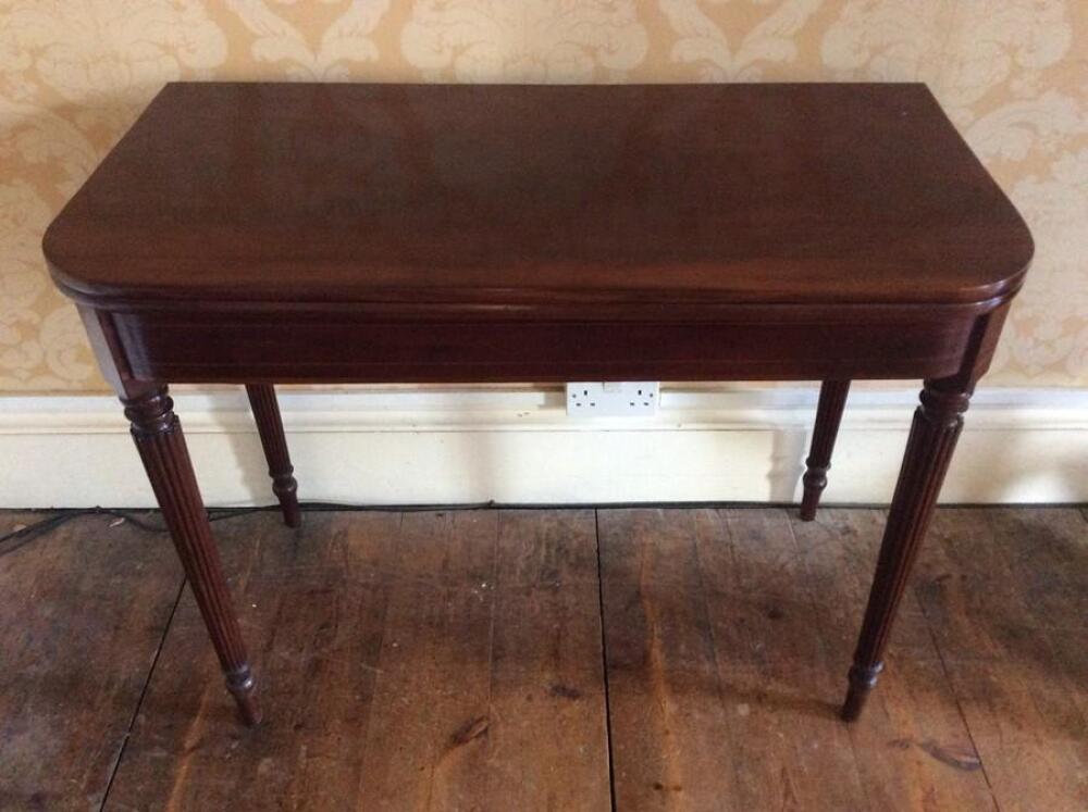 A George III mahogany inlay tea table, circa 1780, a folding twisted ...