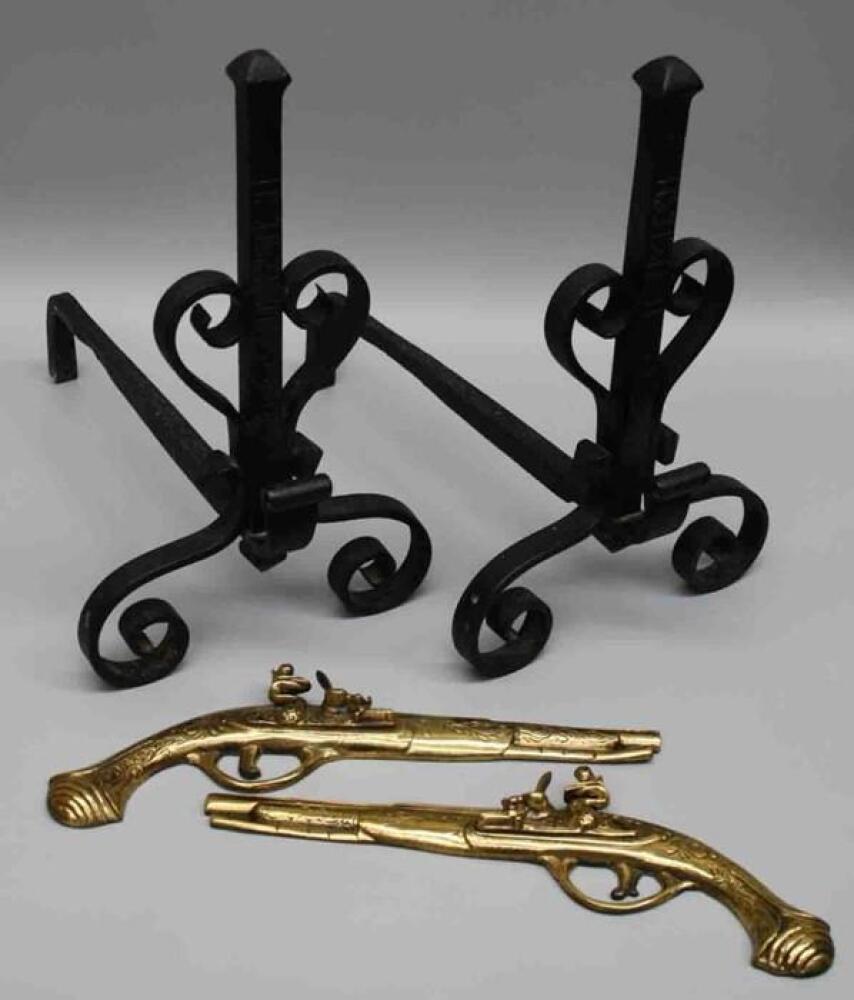 A pair of blacksmith made wrought iron fire dogs and a pair of brass ...