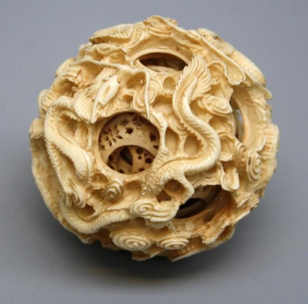 An early 20th century Chinese puzzle ball, probably Canton, 8cm diameter