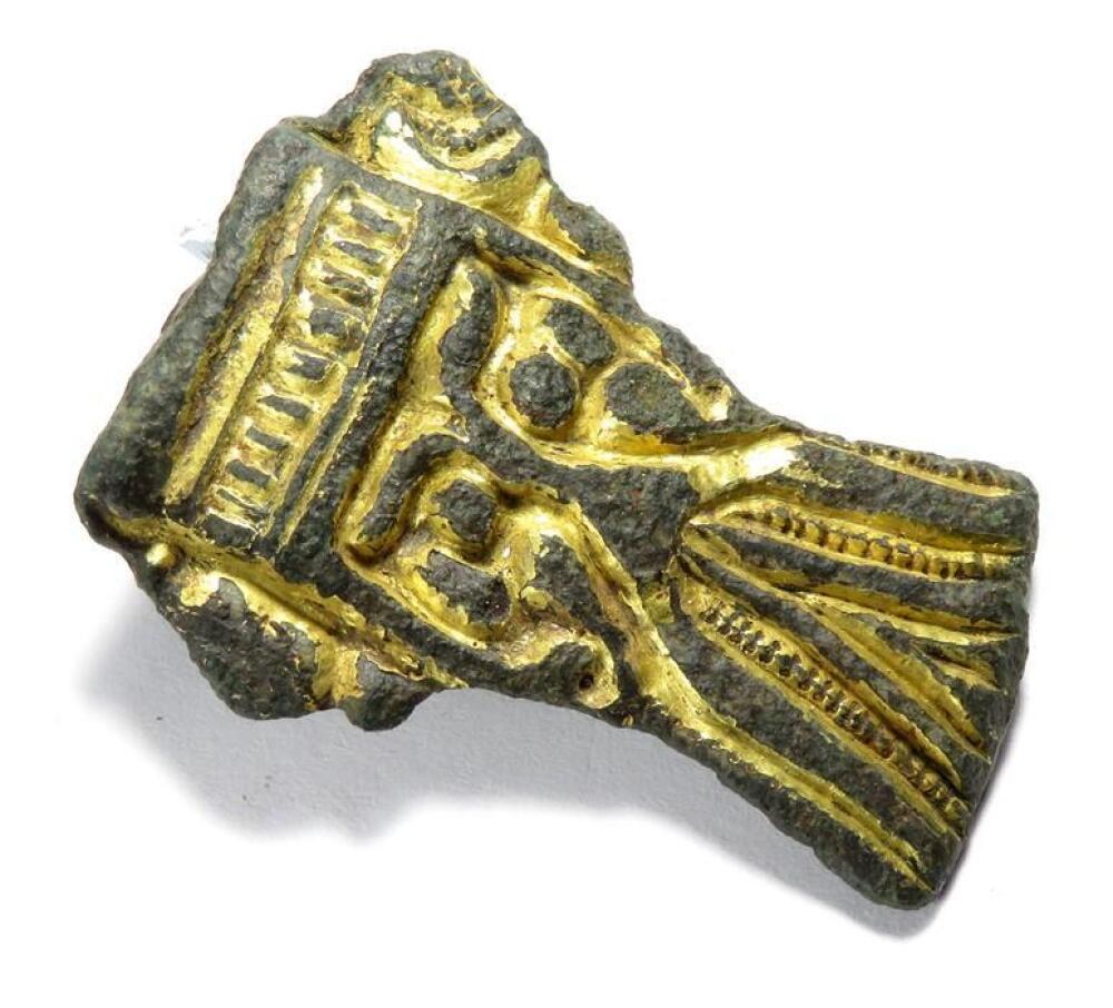 Anglo-Saxon chip-carved facemask mount. A heavily gilded bronze mount ...