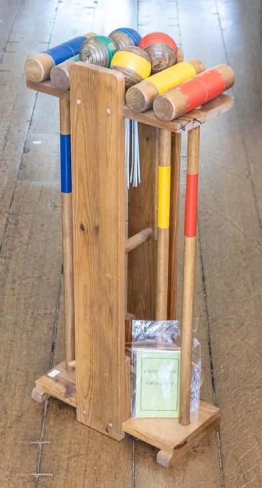 A 20th century croquet set, pine stick holder stand with four leather ...