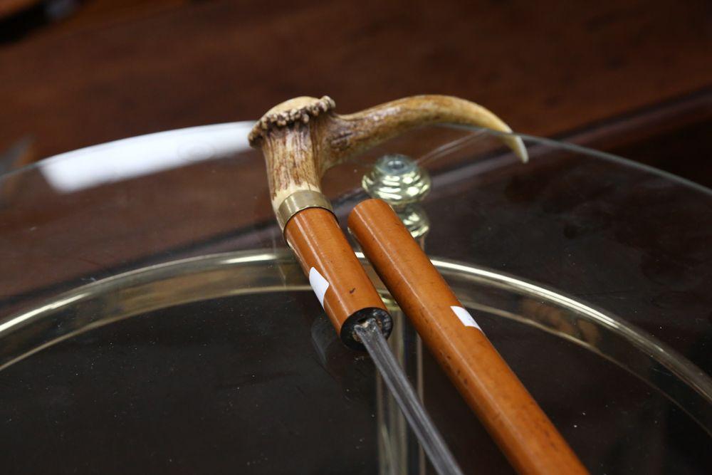 A pollard oak fencing sword with antler handle and a wooden walking cane