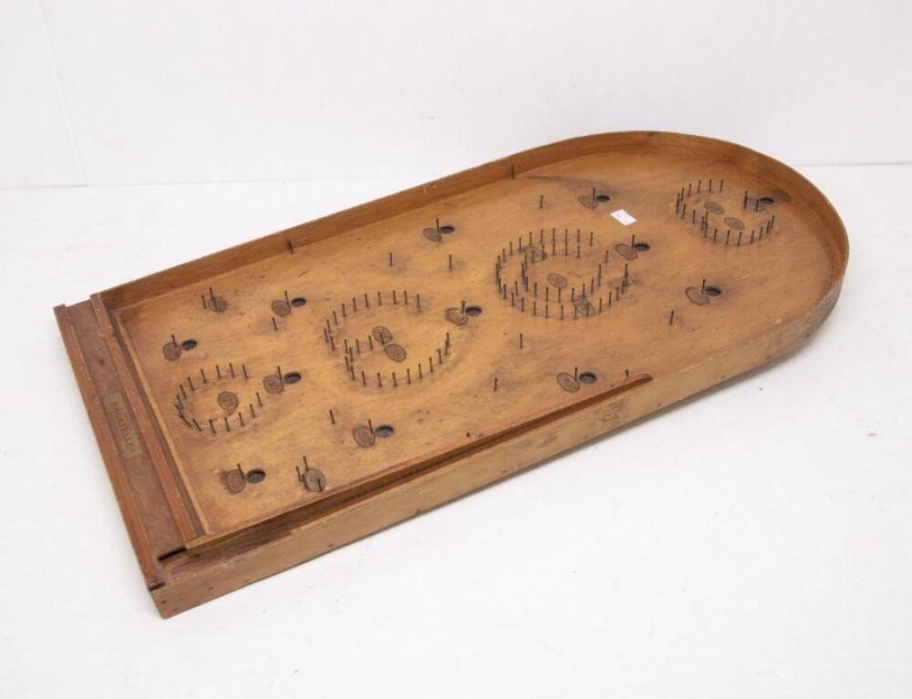 A vintage Bagatelle board with cue