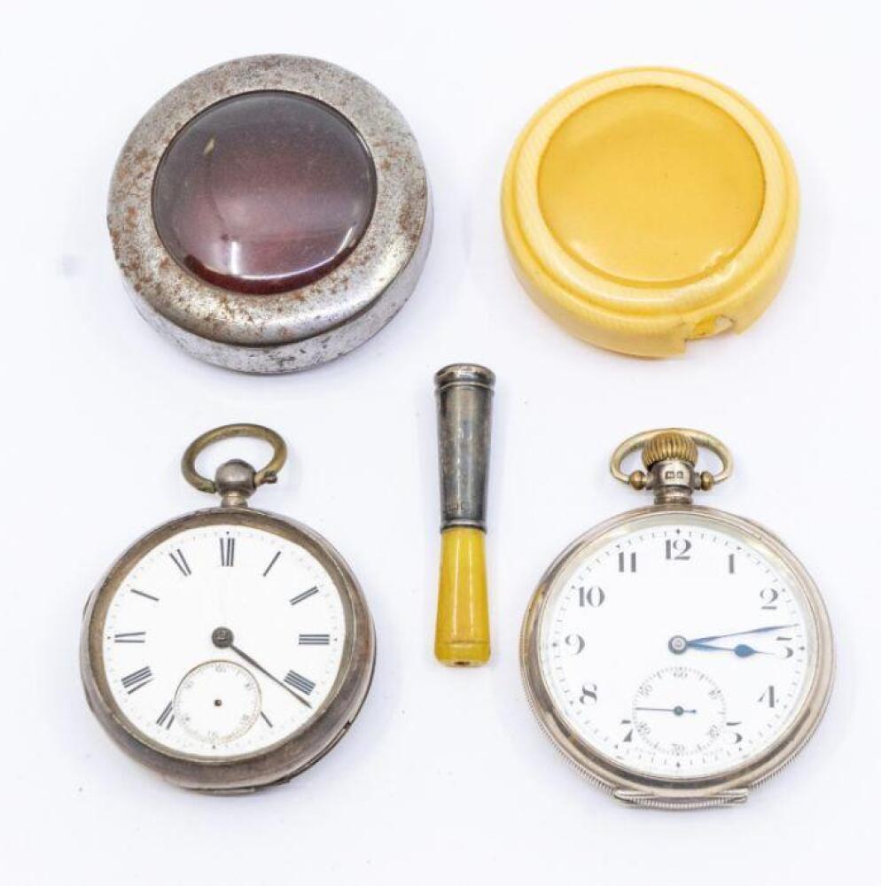 A silver pocket watch with white enamel dial, number markers and ...