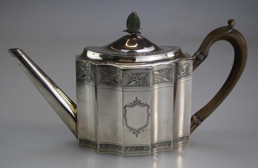 Abraham Taylor, a George III silver teapot of concave panelled form ...