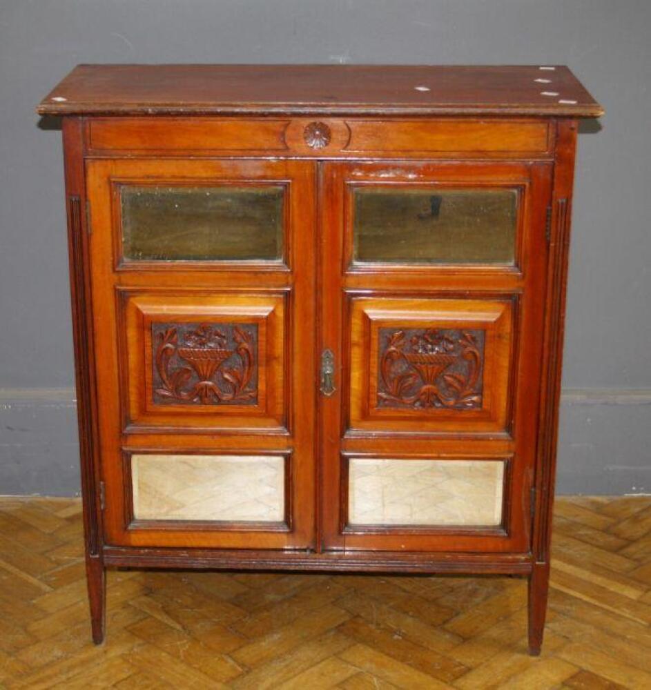 An Edwardian walnut side cabinet, the rectangular top over a pair of ...