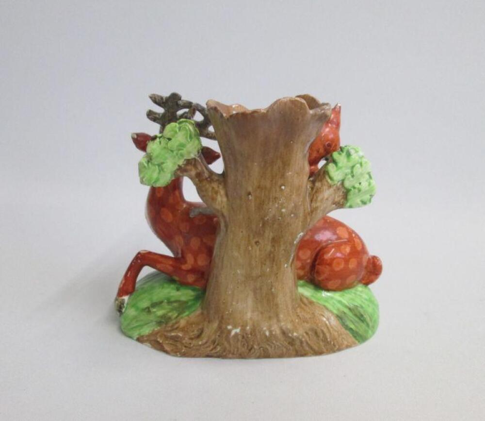 A Staffordshire Spill Holder with a Model of a recumbent Stag and a Fox ...