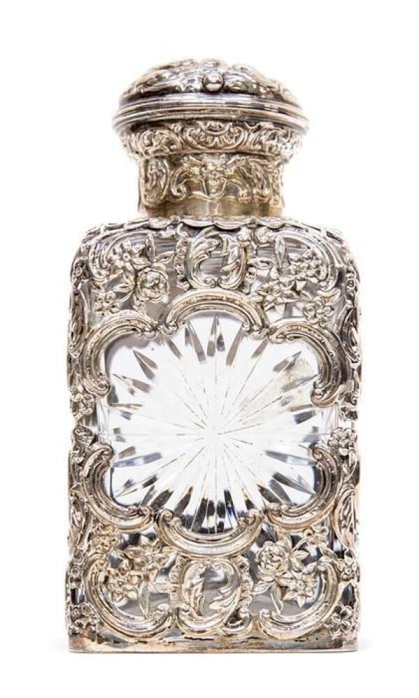 A cut glass cologne bottle, with silver casing, Rococo style, silver ...
