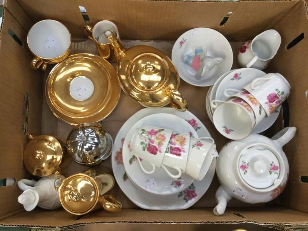A Royal Worcester fireproof gold tea set, together with silver fire ...