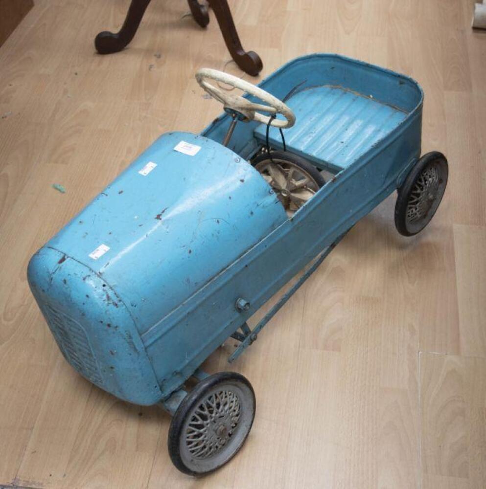 A vintage child's peddle car