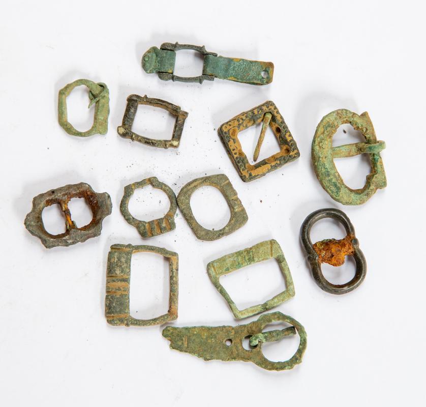 Twelve buckles and related items, mostly Medieval (c. 1250-1400). Of ...