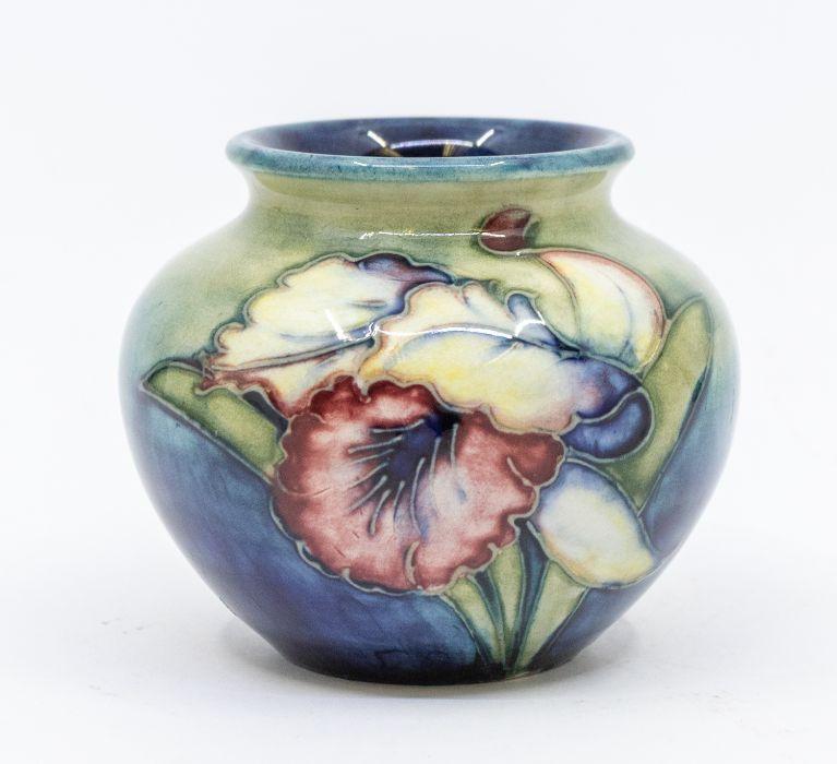 A small Moorcroft Iris patterned green and blue glazed small pot ...