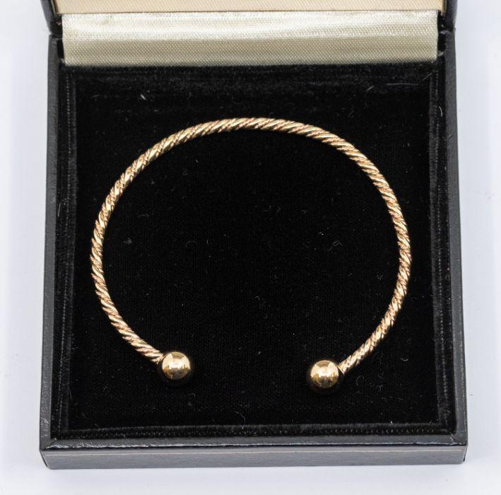 A Clogau welsh gold two colour 9ct gold rope twist torque bangle ...