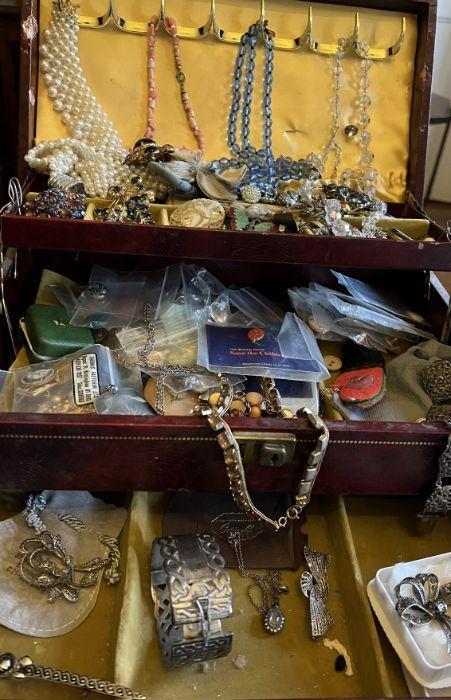 A maroon leatherette case containing a quantity of silver and costume ...