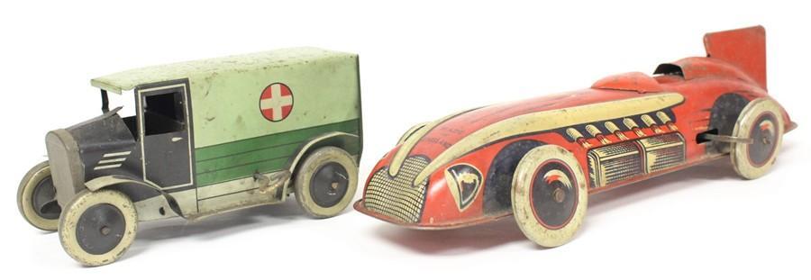 Wells: A tinplate clockwork racing car, no driver, wheels are loose ...