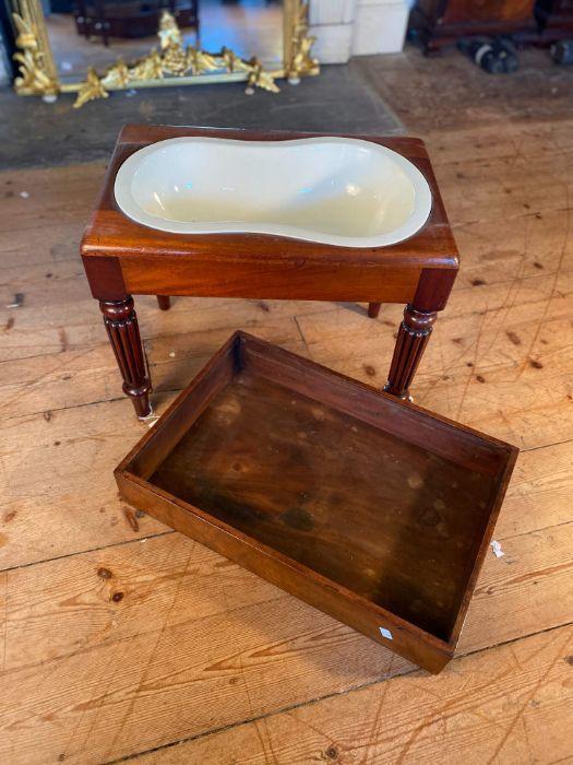 A Regency flamed mahogany bedside commode, the top enclosing ceramic ...