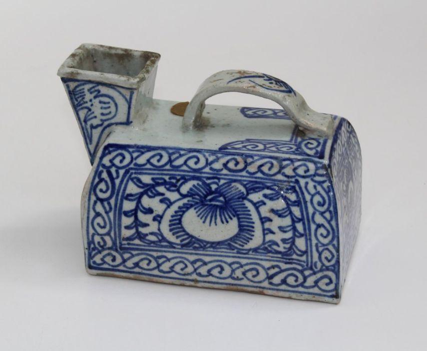 A Chinese pottery blue and white urinal, of typical form with loop ...