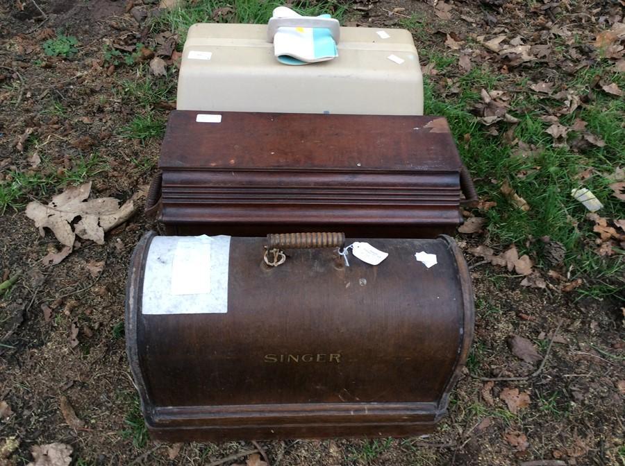 Three 20th century sewing machines.