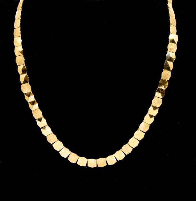 A 9ct gold collarette necklace comprising hexagonal polished faceted ...