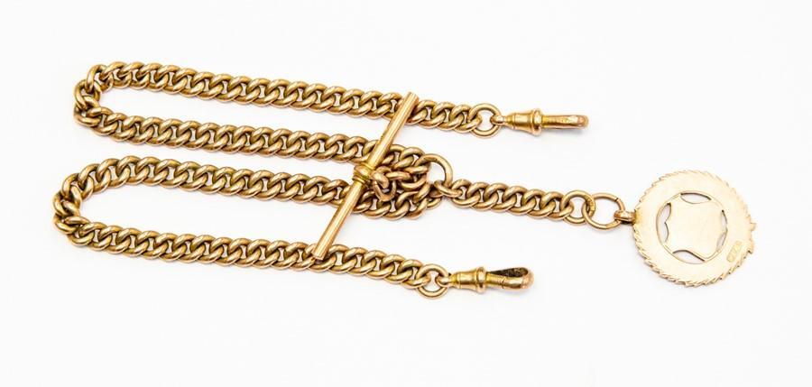 A 9ct gold double albert watch chain with medallion fob, swivel and T ...