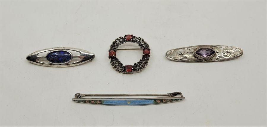 Four various silver and white metal brooches, to include an enamelled ...