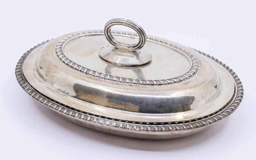 A George V silver oval small entree dish and cover, gadroon borders ...
