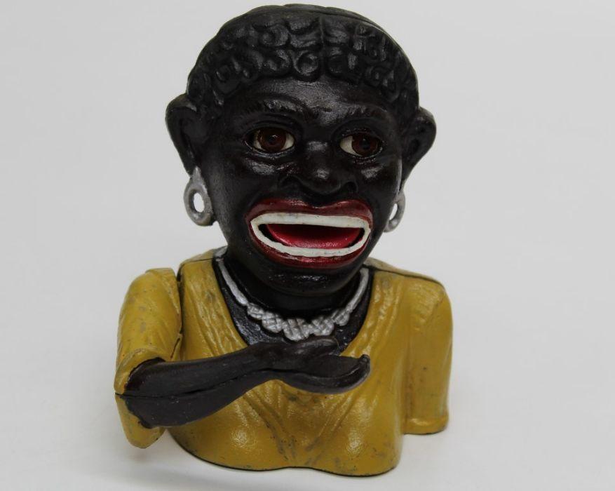 A late 19th / early 20th century cast iron money box, ' Dinah' with ...