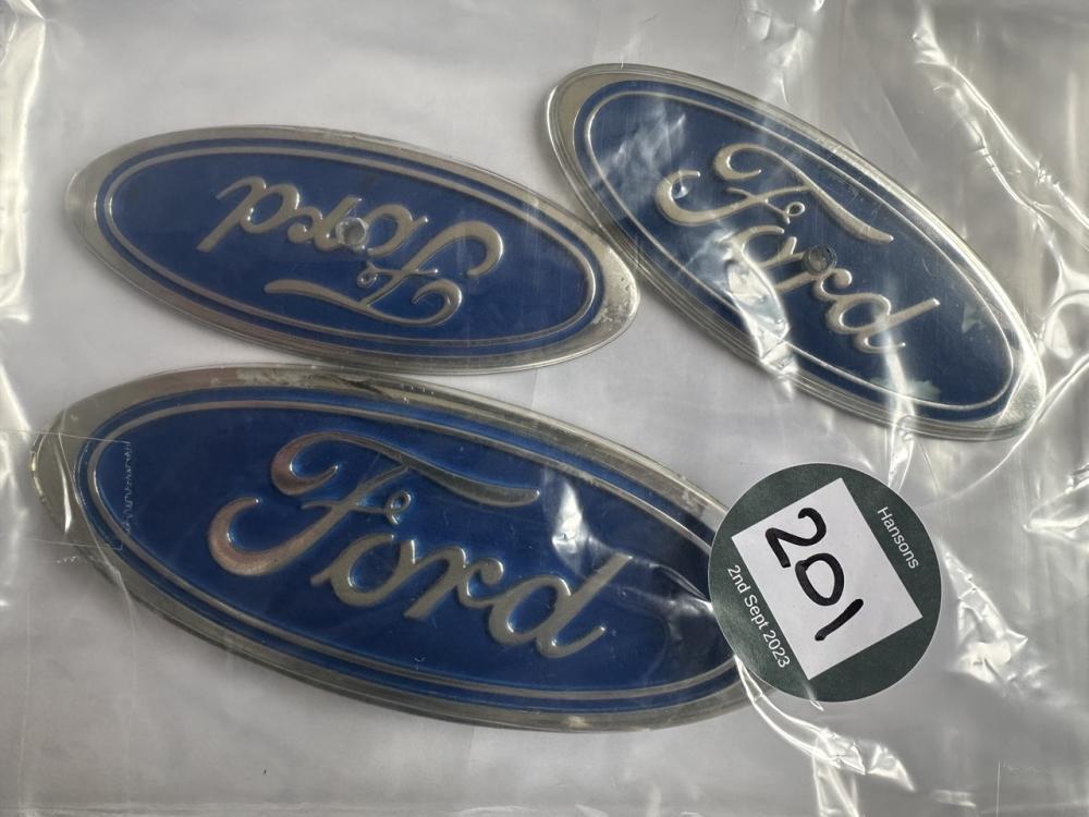 Three Ford vehicle badges