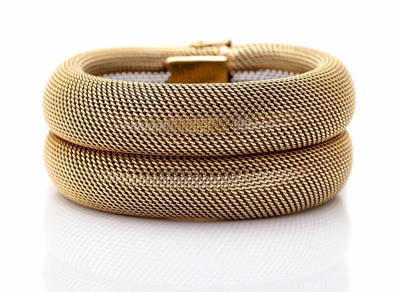 A continental 14ct gold mesh bangle, comprising double domed mesh rows ...