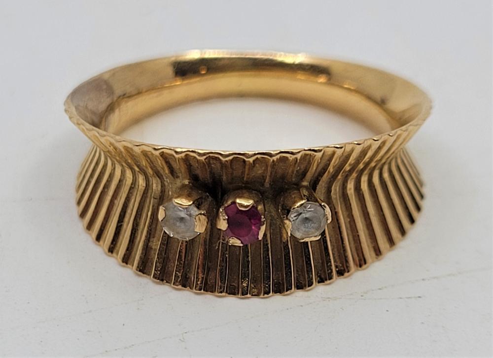 A precious yellow metal, ruby and clear stone ring, set mixed round cut ...