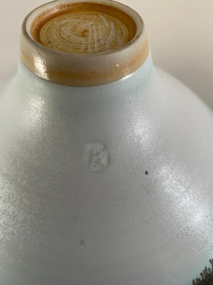 A porcelain footed bowl after Lucie Rie with bronzed decoration to rim ...