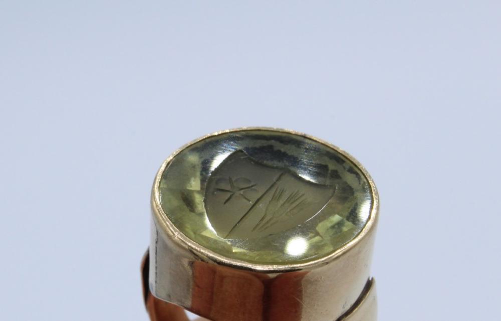 A yellow metal citrine intaglio ring featuring an intaglio with faceted ...
