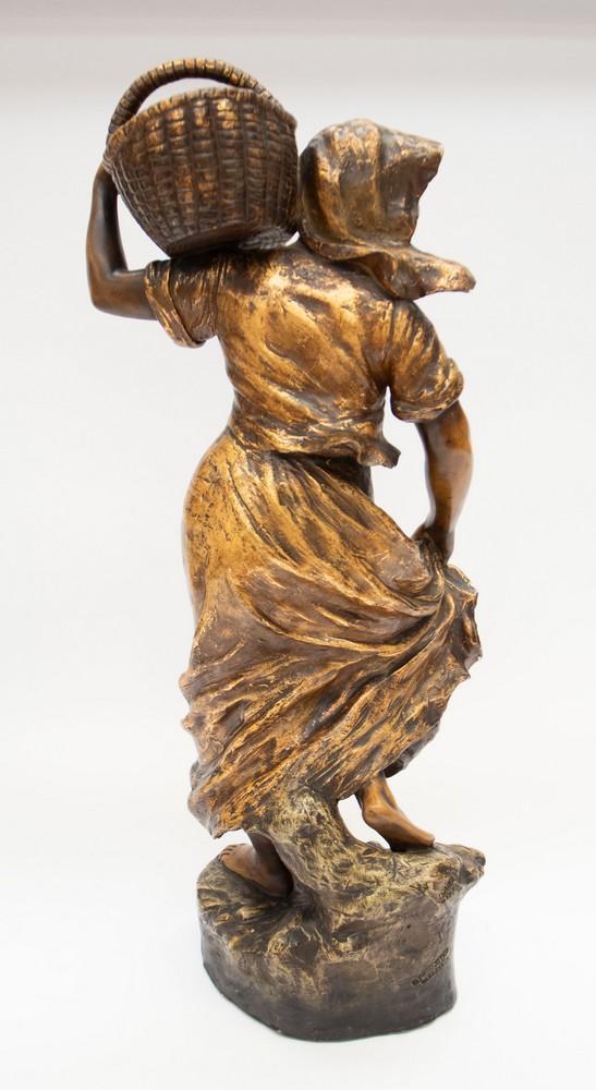 Goldscheider - A large terracotta figure of a young lady with a wicker ...
