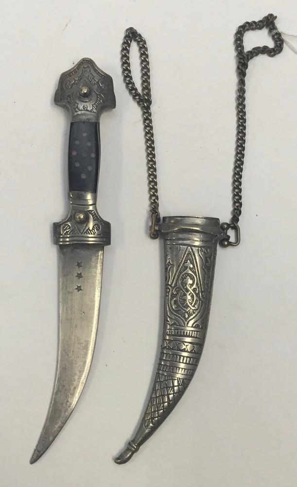 A Middle Eastern style Khanjar knife with scabbard. Wooden grips with ...