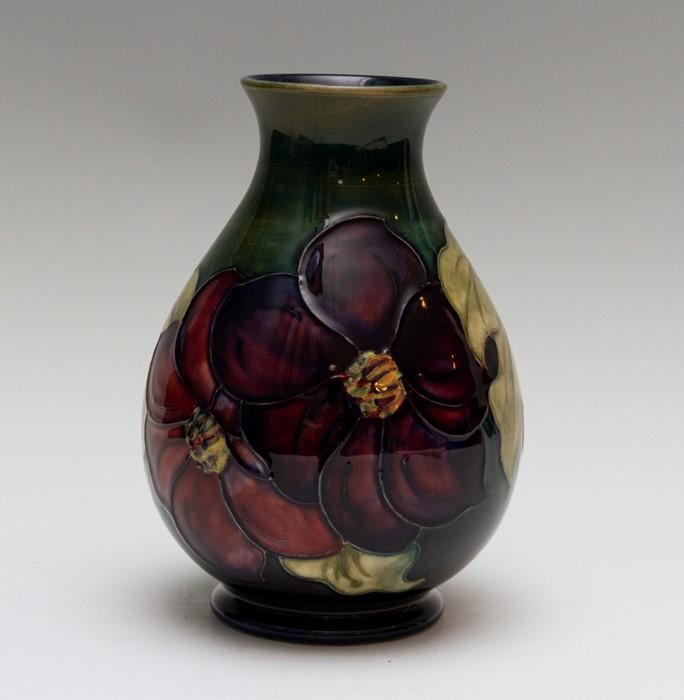 A Moorcroft clematis baluster vase, impressed marks, green W.M monogram ...