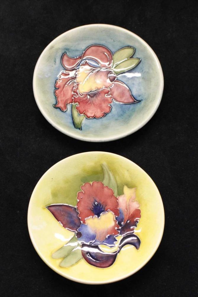 A Moorcroft orchid pattern pin dish and a similar example, both with ...