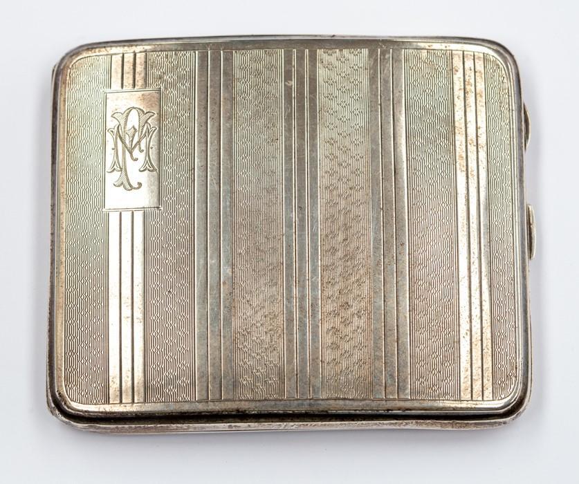 A George V oblong cigarette case, engine turned decorated, with ...