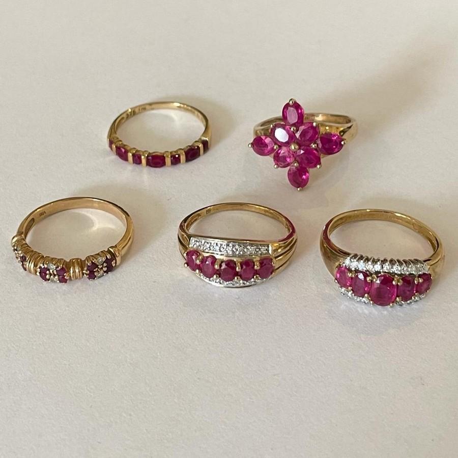 A collection of five 9ct yellow gold ruby set rings. To include three ...