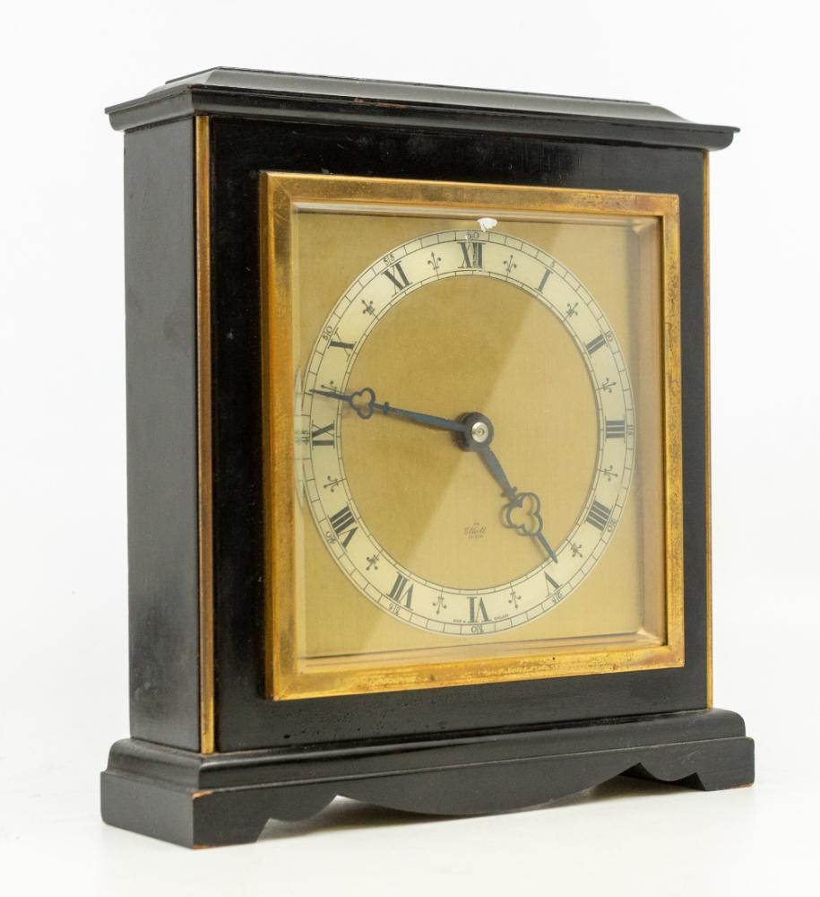 An ebonised Elliot mantel clock with Roman numerals and brass dial.