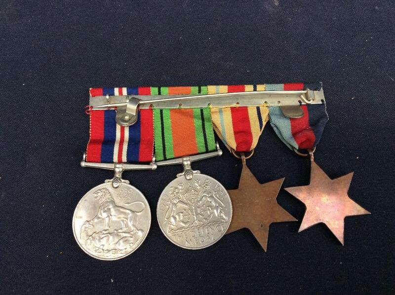 A collection of WWII medals on chest bar with the African star.