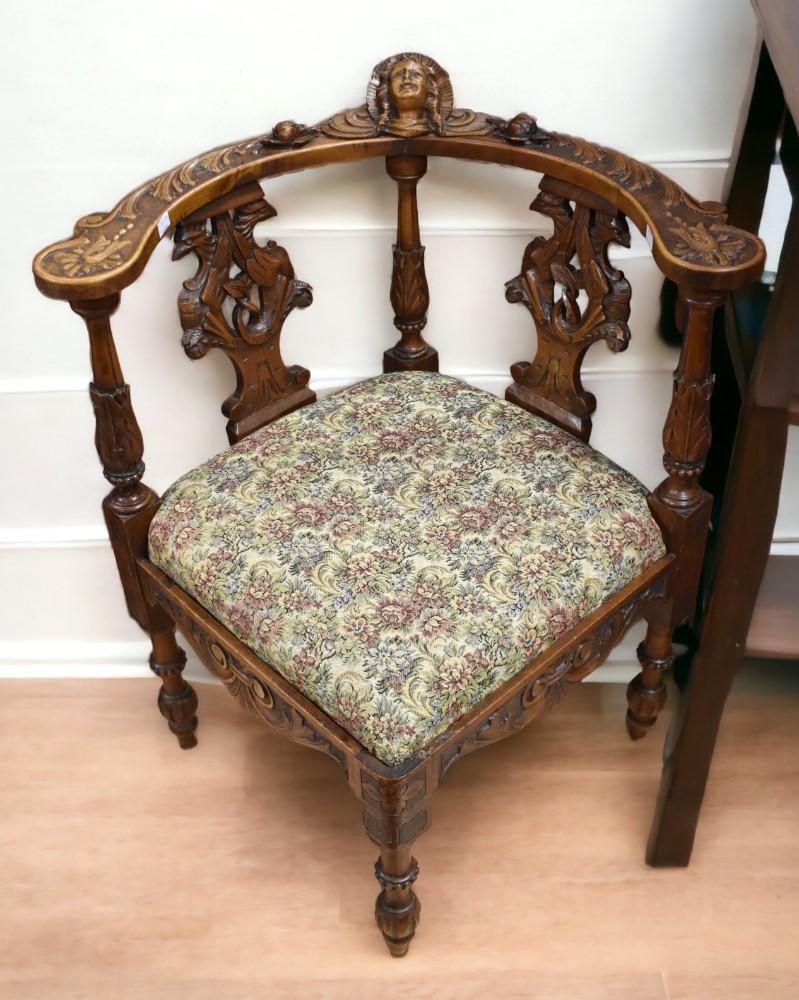 A heavily carved continental corner library chair (c1870) in the Black ...