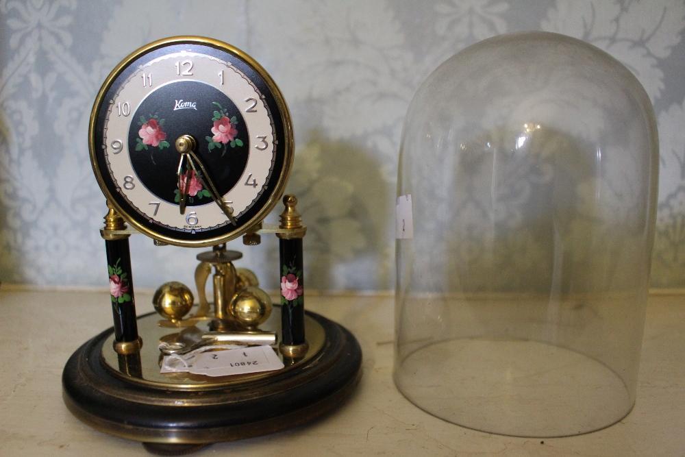 A Roma of Germany 400 day clock under glass dome, together with ...