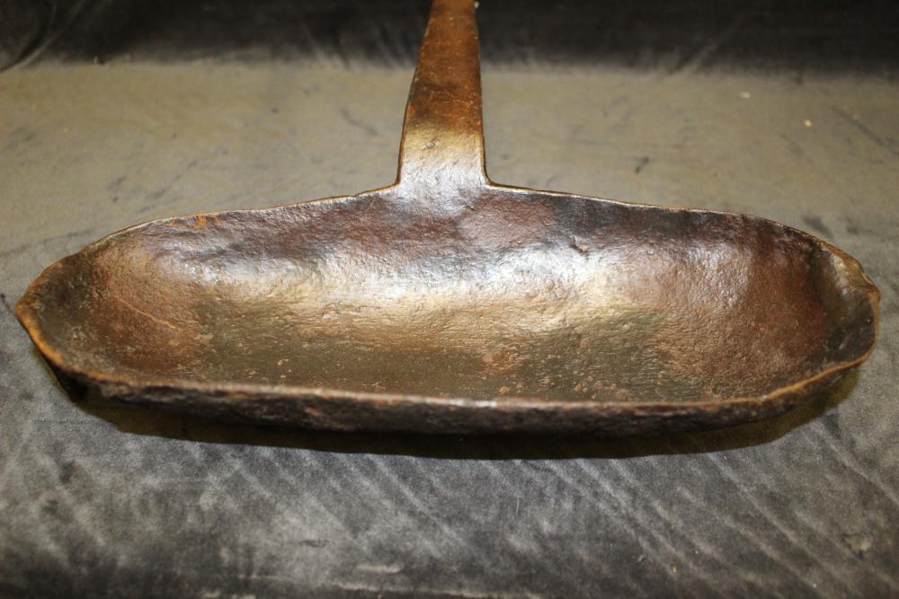 A 17th/18th century wrought iron grisset on three feet, 40cm long * The ...