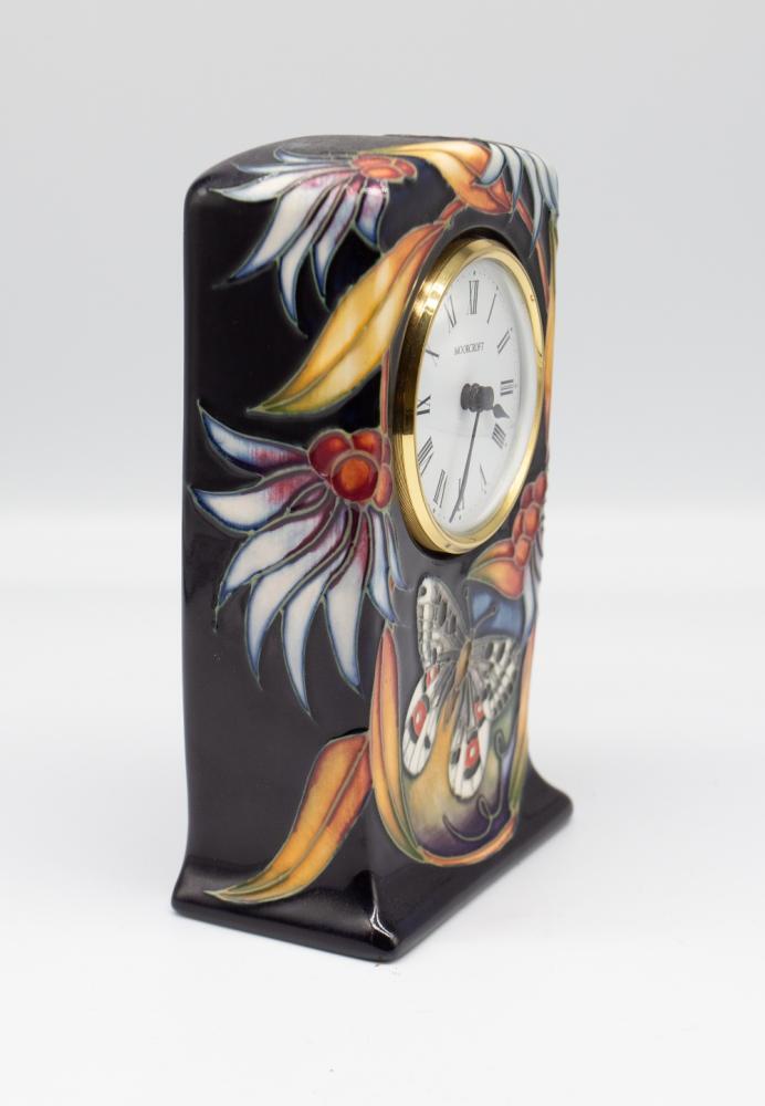 Moorcroft Pottery - an 'Apollo' patterned mantel clock, impressed marks ...