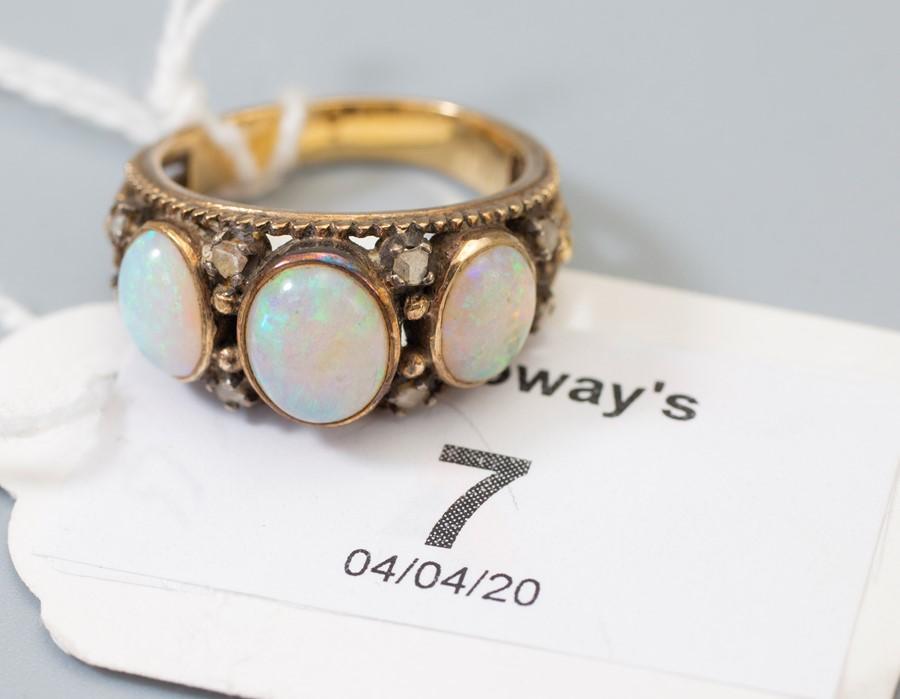 A three stone opal half hoop ring, the slightly graduated opals in rub ...