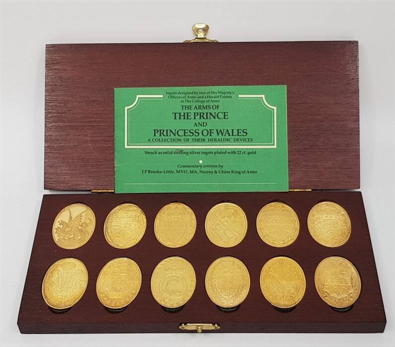 A Danbury Mint collection of twelve sterling silver ingots plated in ...