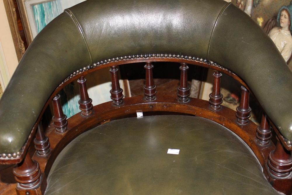 Green swivel captains chair. Some marks to front seat and arm.